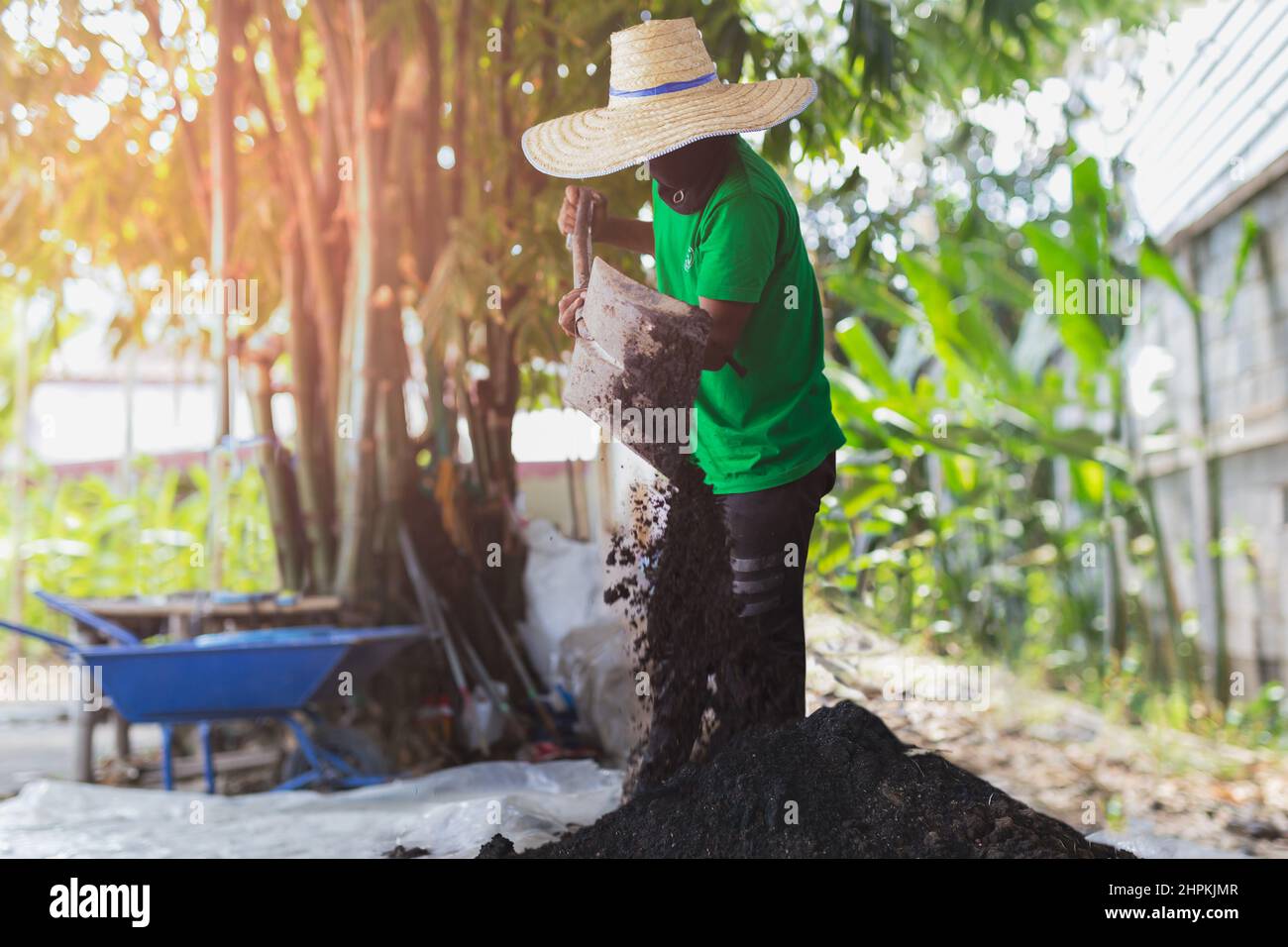 Man worker mixing fertilizer soil for plantation Stock Photo - Alamy