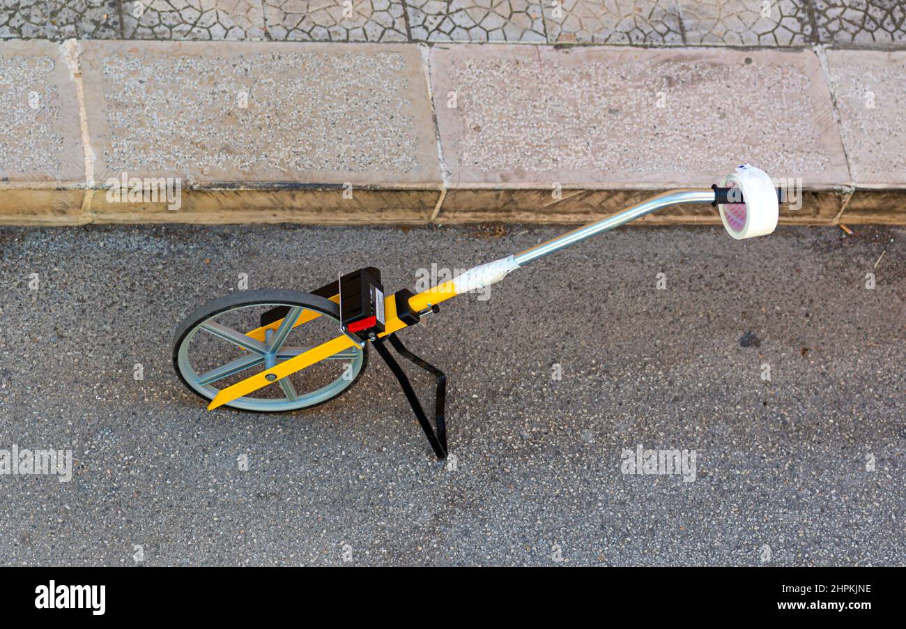 Surveyor with measuring wheel (odometer) detects the length of an ...