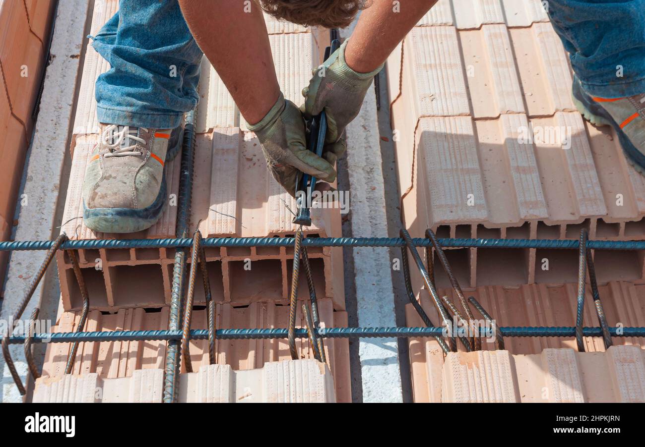 Tying reinforcing steel bars (rebar) for the construction. Tightening ...