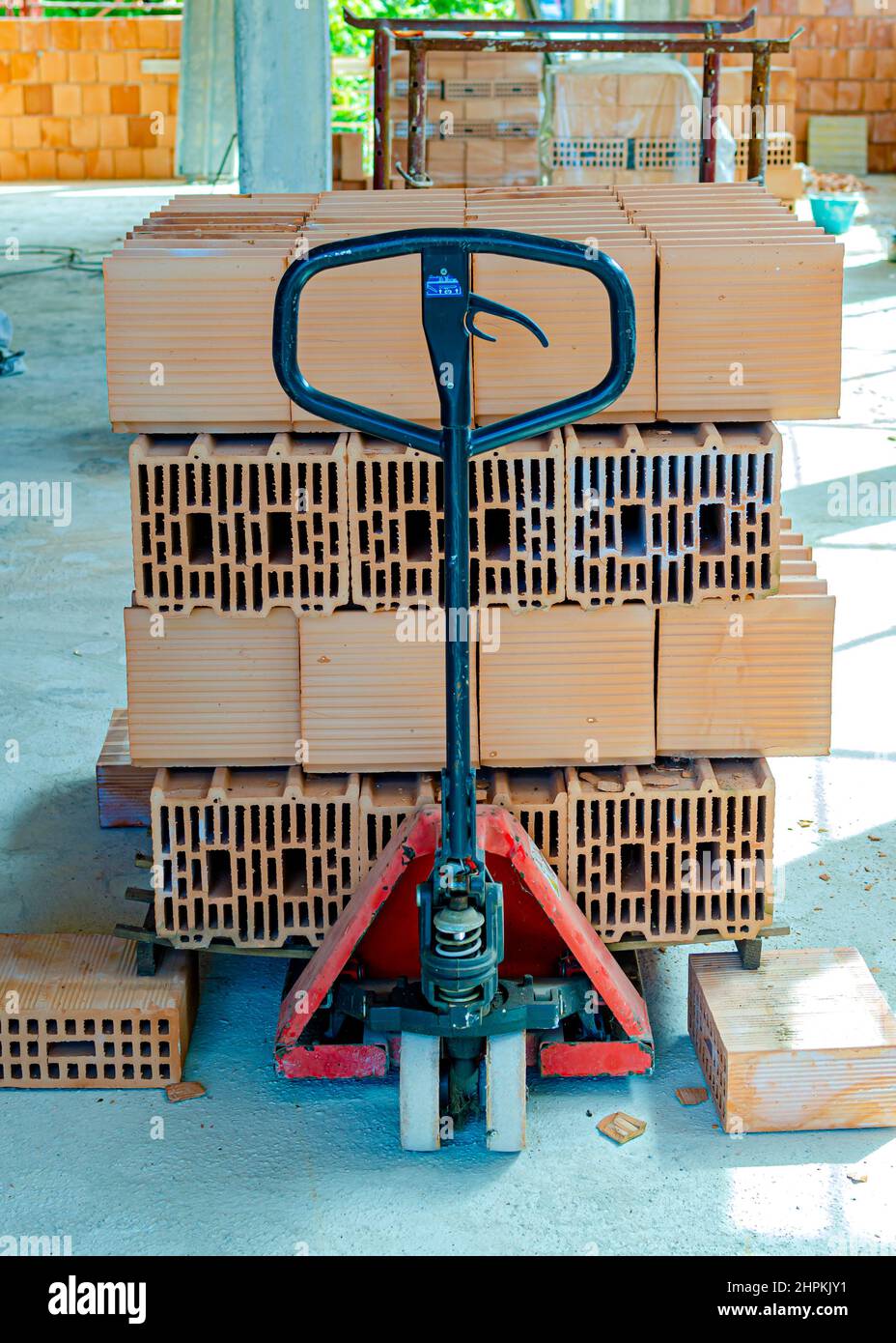 Red brick stack on the pallet. Material, package Stock Photo - Alamy