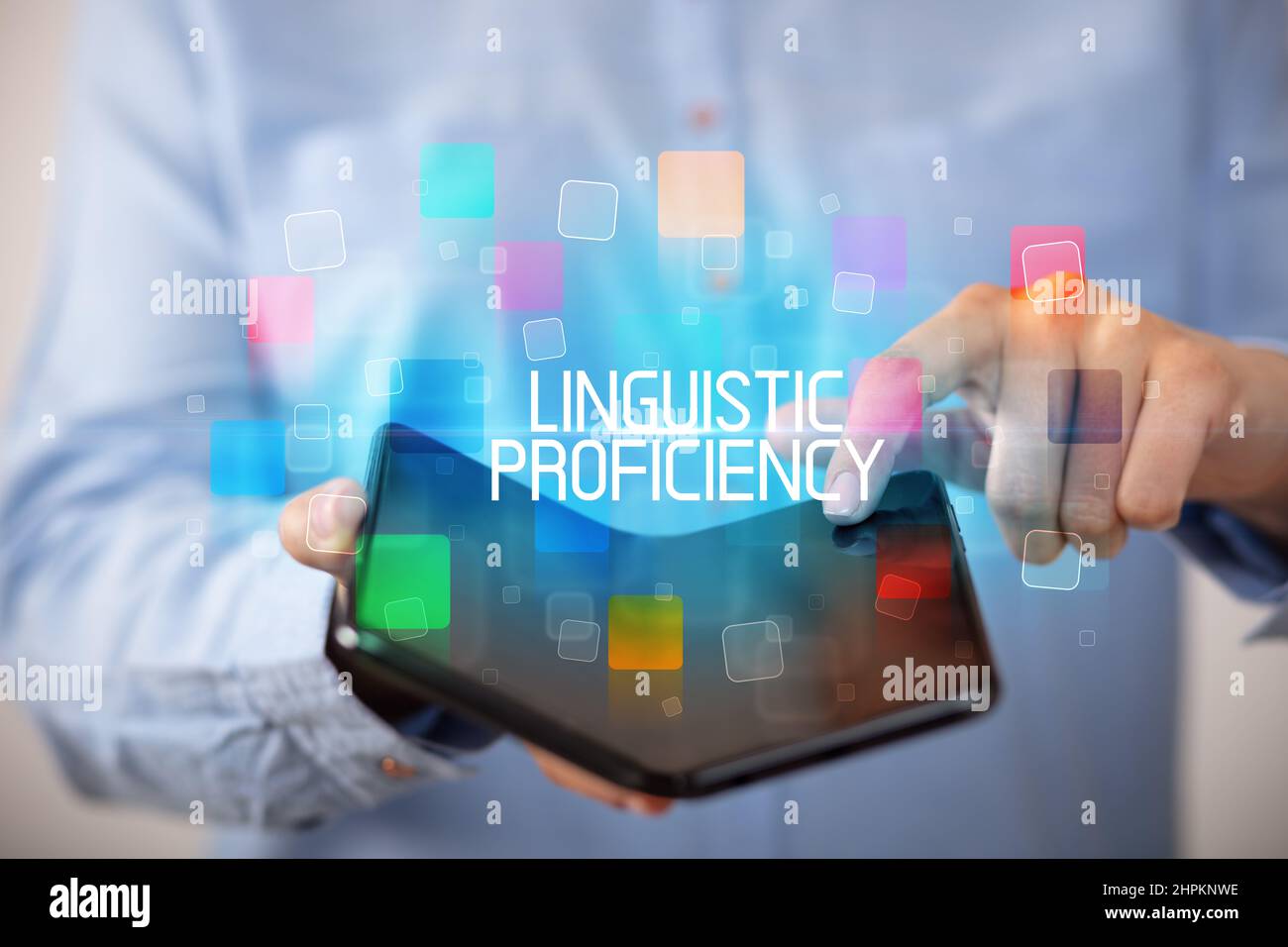 Young man holding a foldable smartphone Stock Photo - Alamy