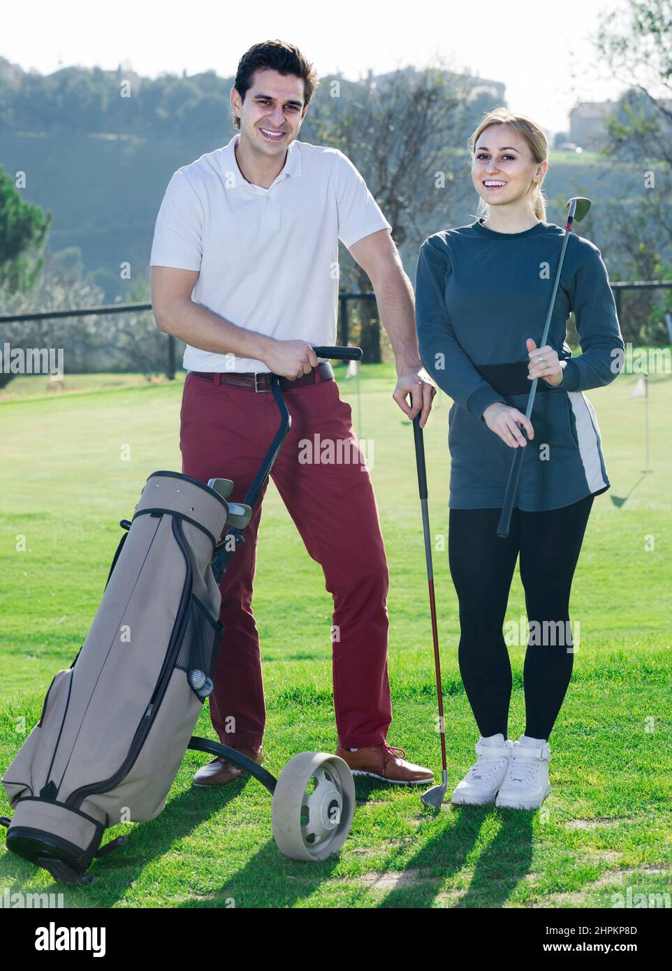 Male and female golfers ready for team play at golf course Stock Photo ...