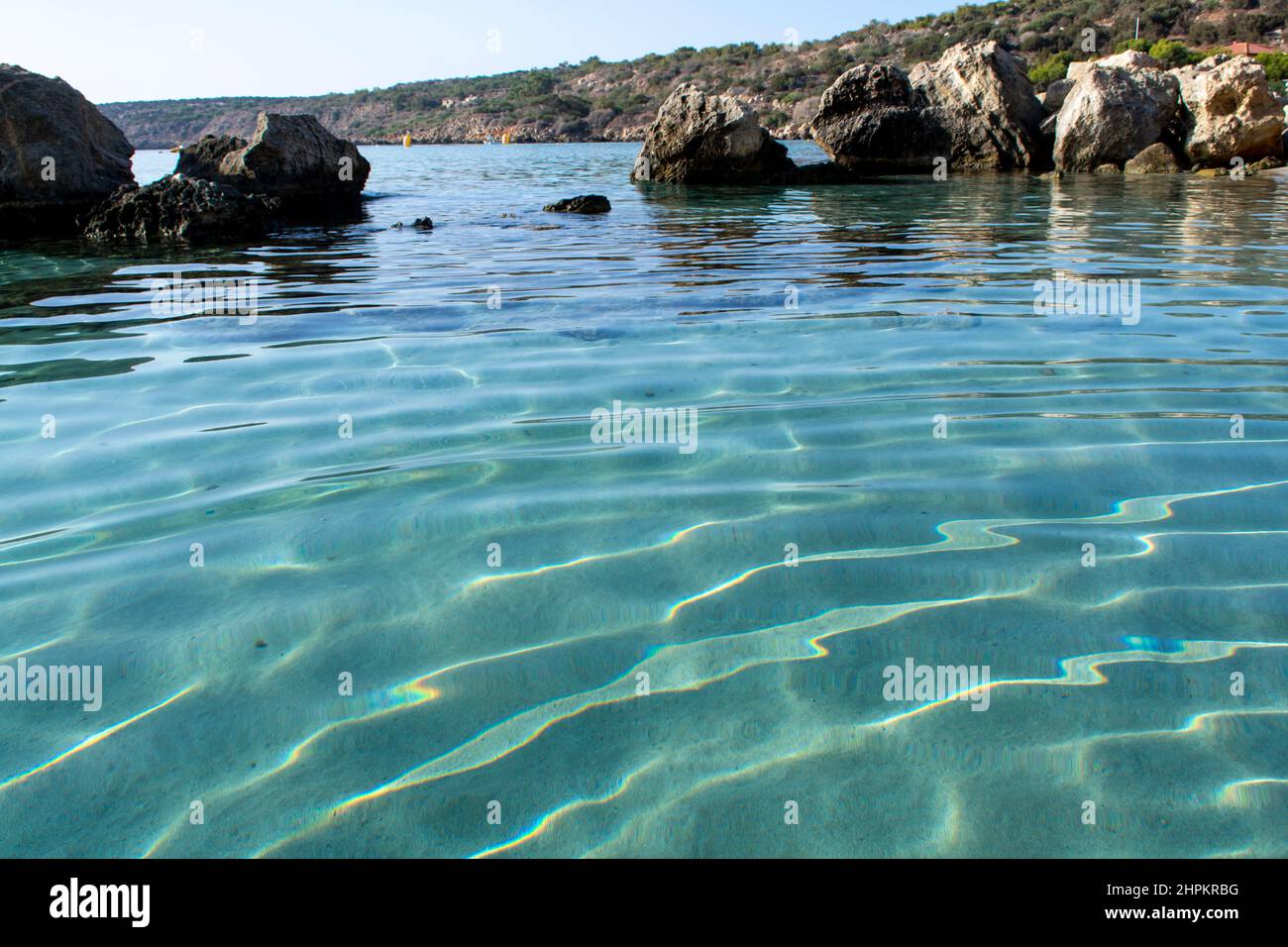 Crystal clear blue water of Mediterranean sea and yellow rocks in on ...