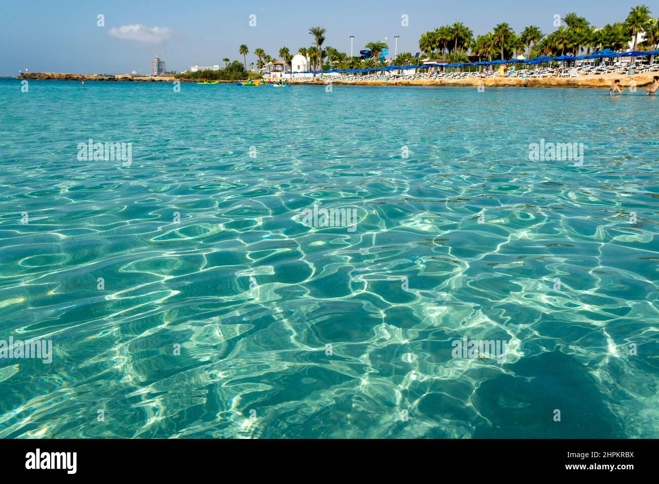 Crystal clear blue water of Mediterranean sea on white sandy Nissi ...