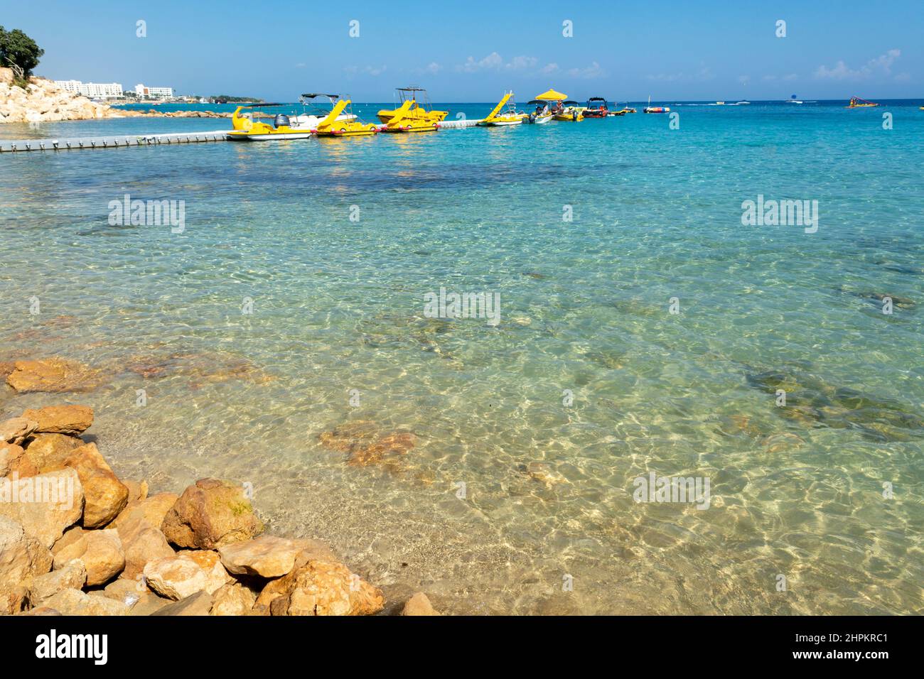 Crystal clear blue water of Mediterranean sea on white sandy Fig tree ...