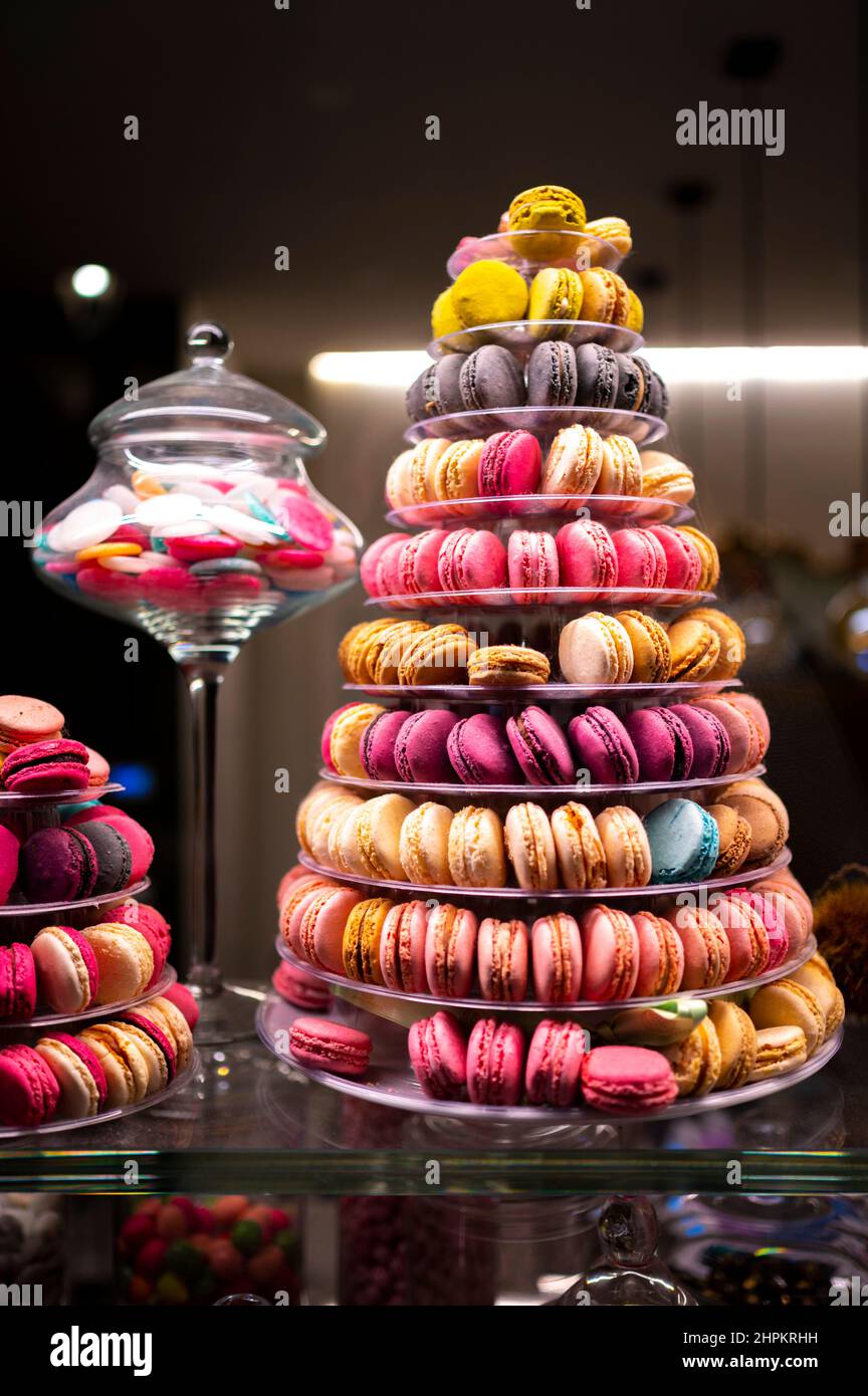 Candy shop display with colorful pyramid of French macarons biscuits at ...