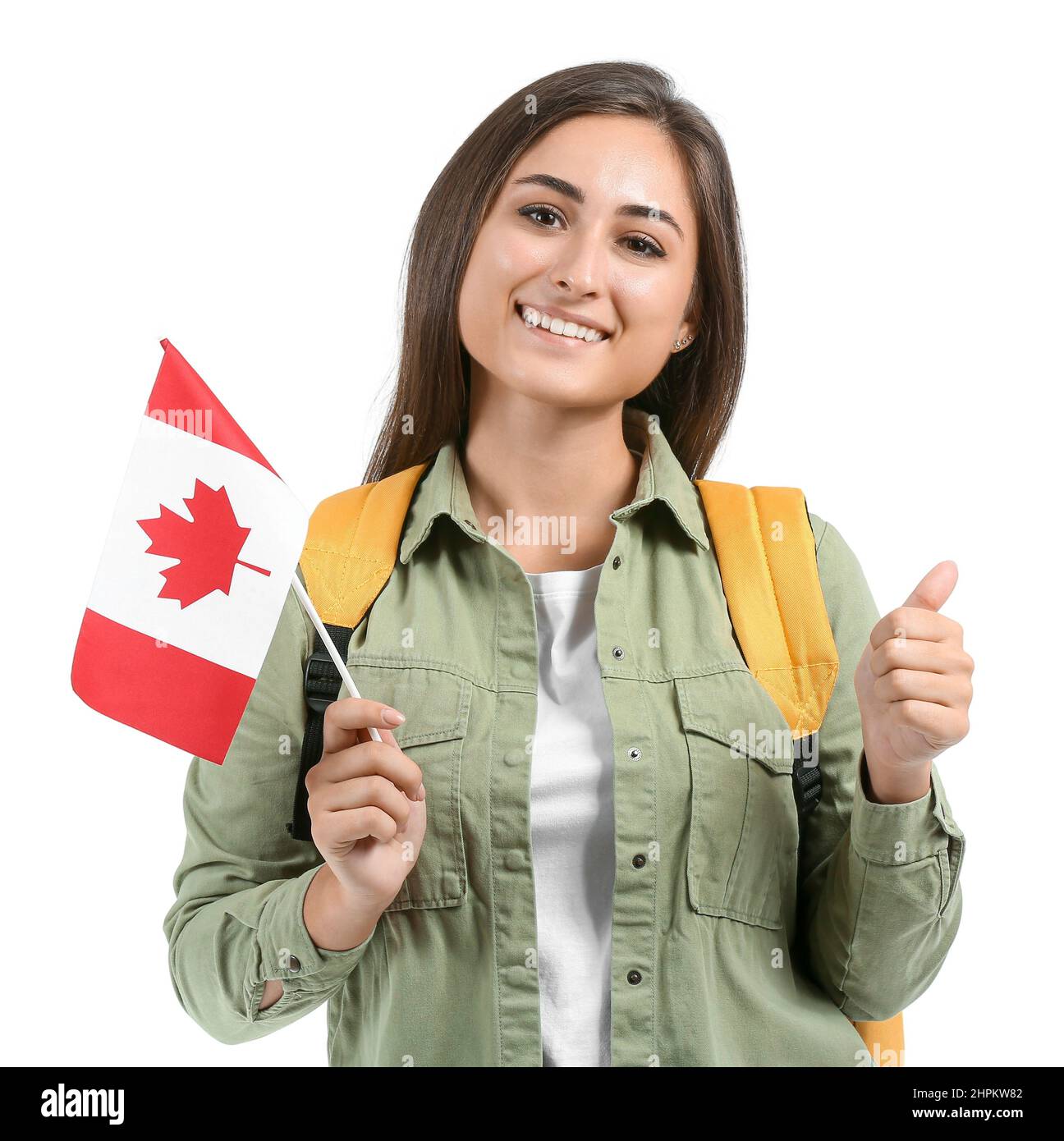 Young female student with national flag of Canada showing thumb-up ...