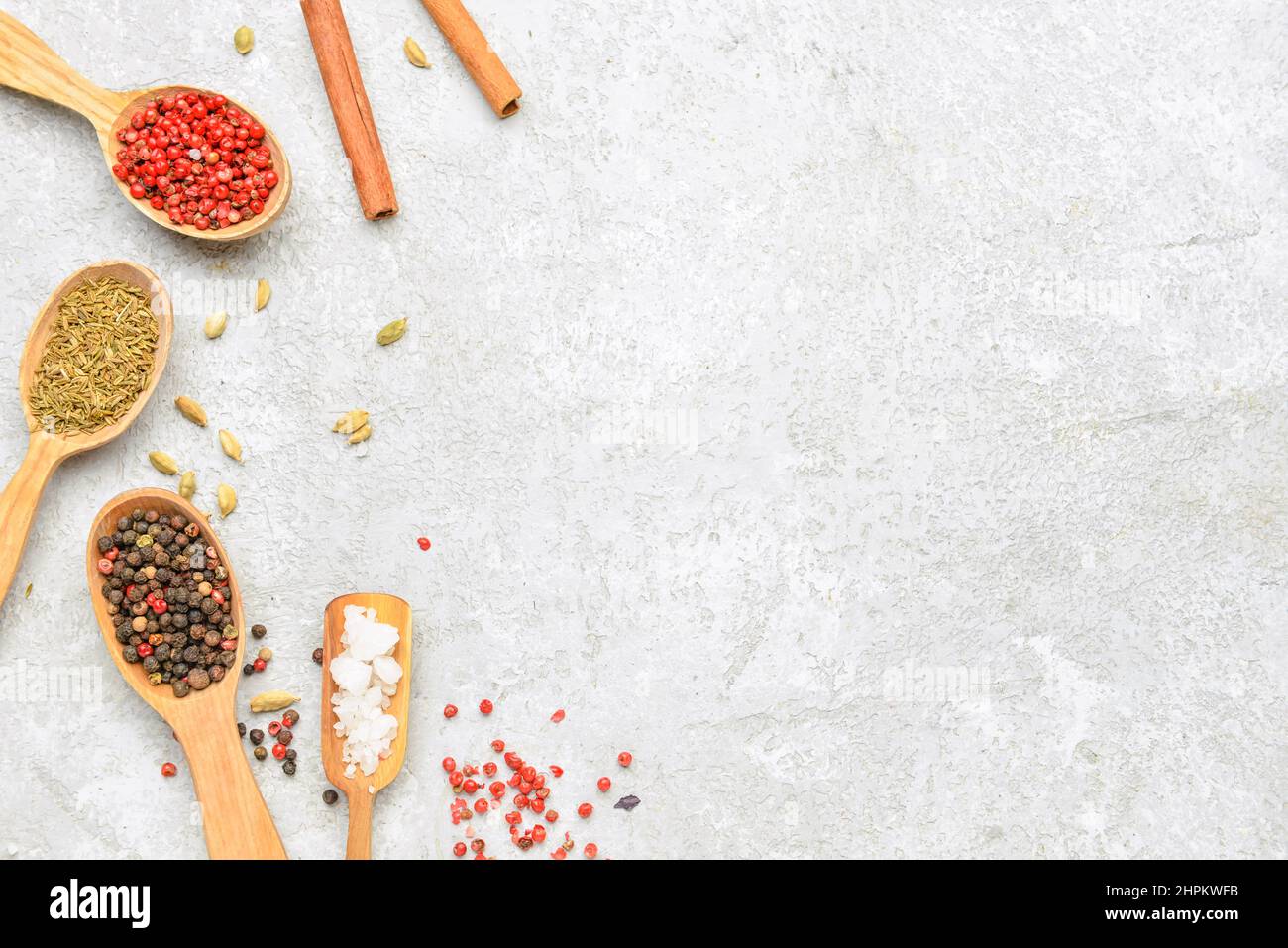 Spoons with aromatic spices on light background Stock Photo - Alamy