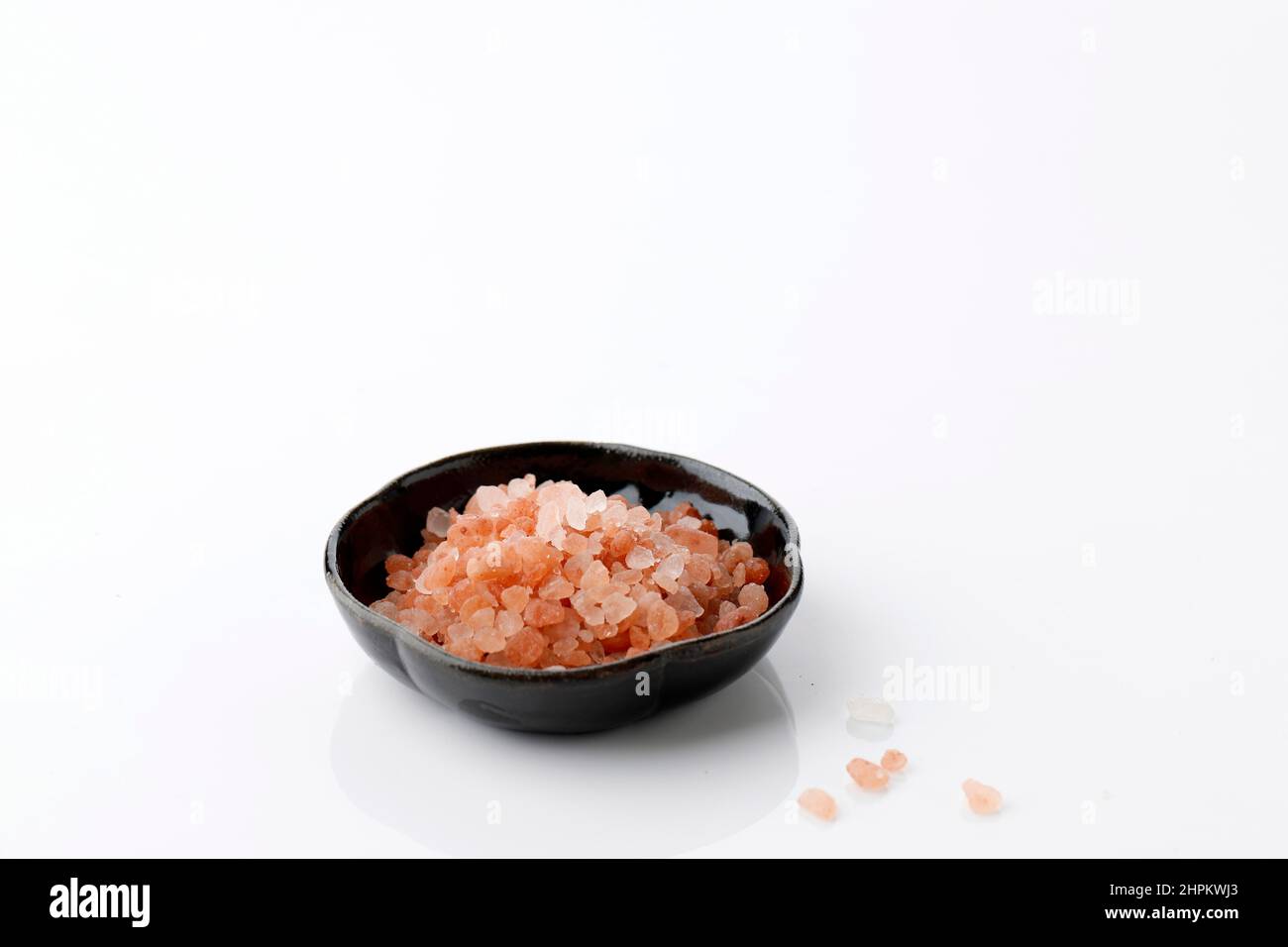 Pink salt from the Himalayas; photo on white background Stock Photo - Alamy