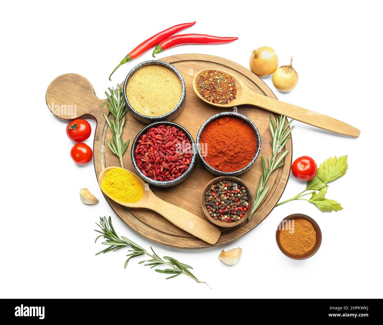 Wooden board with aromatic spices, herbs and vegetables on white ...