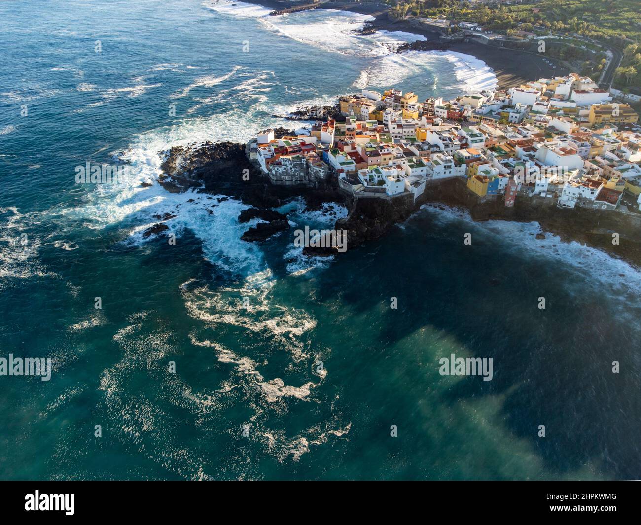 Aerial view on colorful houses and black lava rocks in small fisherman ...