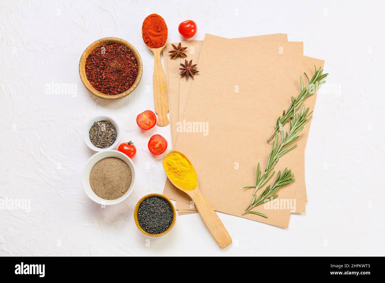 Composition with aromatic spices and blank paper sheets on light ...