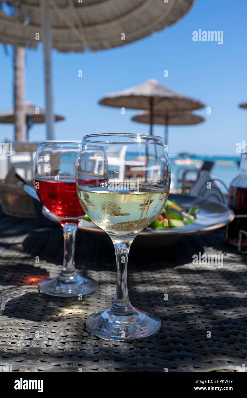Drinking of cold rose and white wines in lounge bar on sunny sandy ...