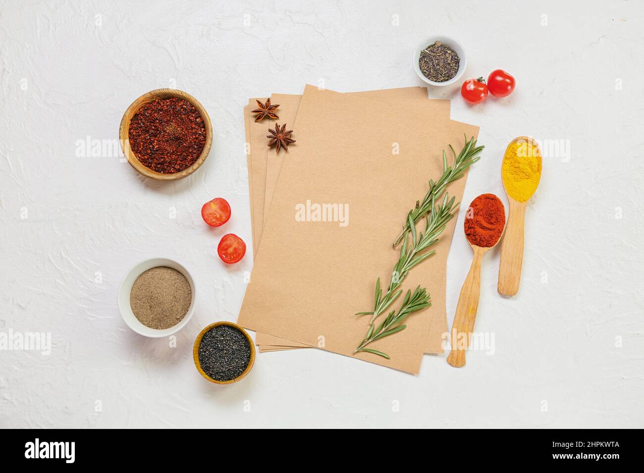 Composition with aromatic spices and blank paper sheets on light ...