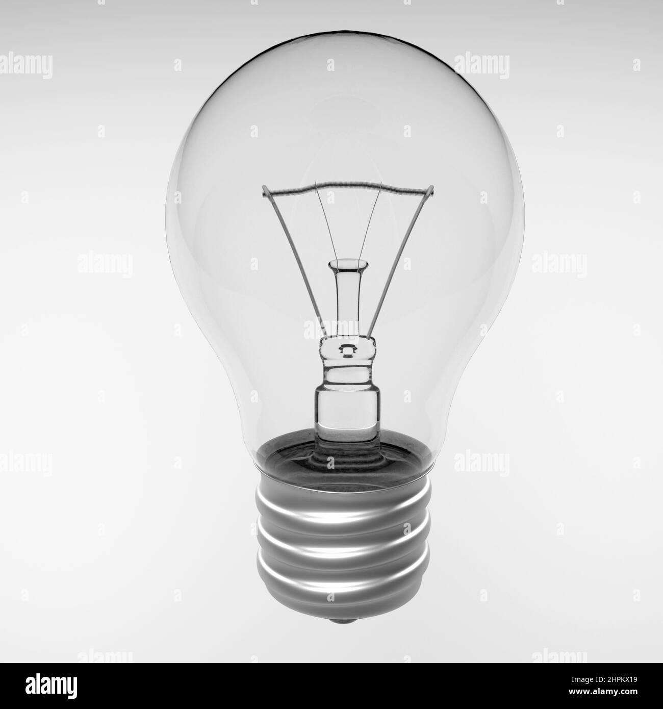 Incandescent light bulb with a clear glass bulb close-up. A grayscale ...