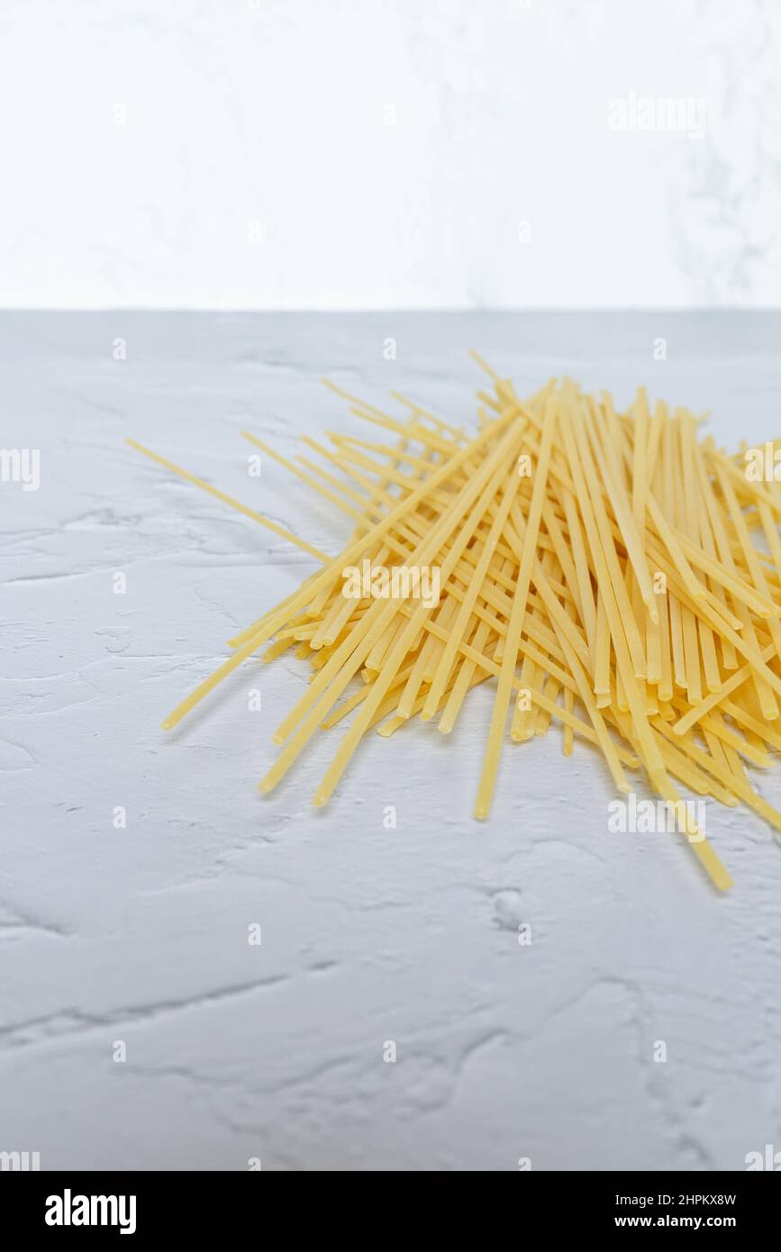 A series of typical italian pasta Linguine, uncooked, on white ...