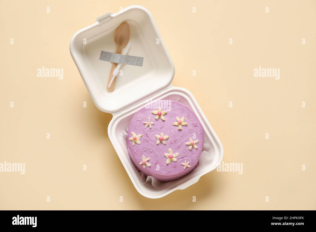 Plastic lunch box with tasty bento cake on beige background Stock Photo ...