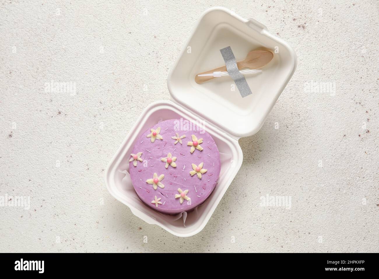 Plastic lunch box with tasty bento cake on light background Stock Photo ...