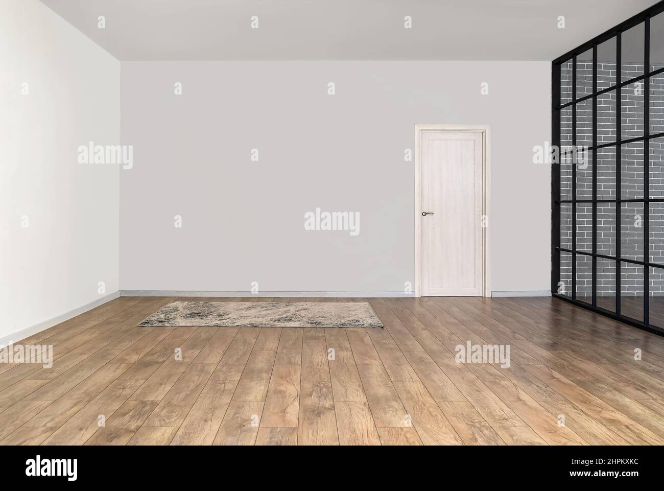 View of big empty room with door and carpet Stock Photo - Alamy