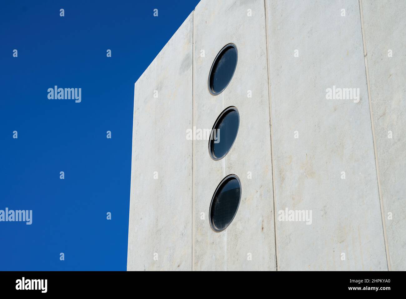 Exterior view of a building with circle-shaped windows on clear sky ...