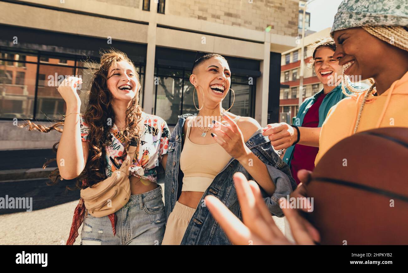 Having fun in the city streets. Group of generation z friends laughing ...
