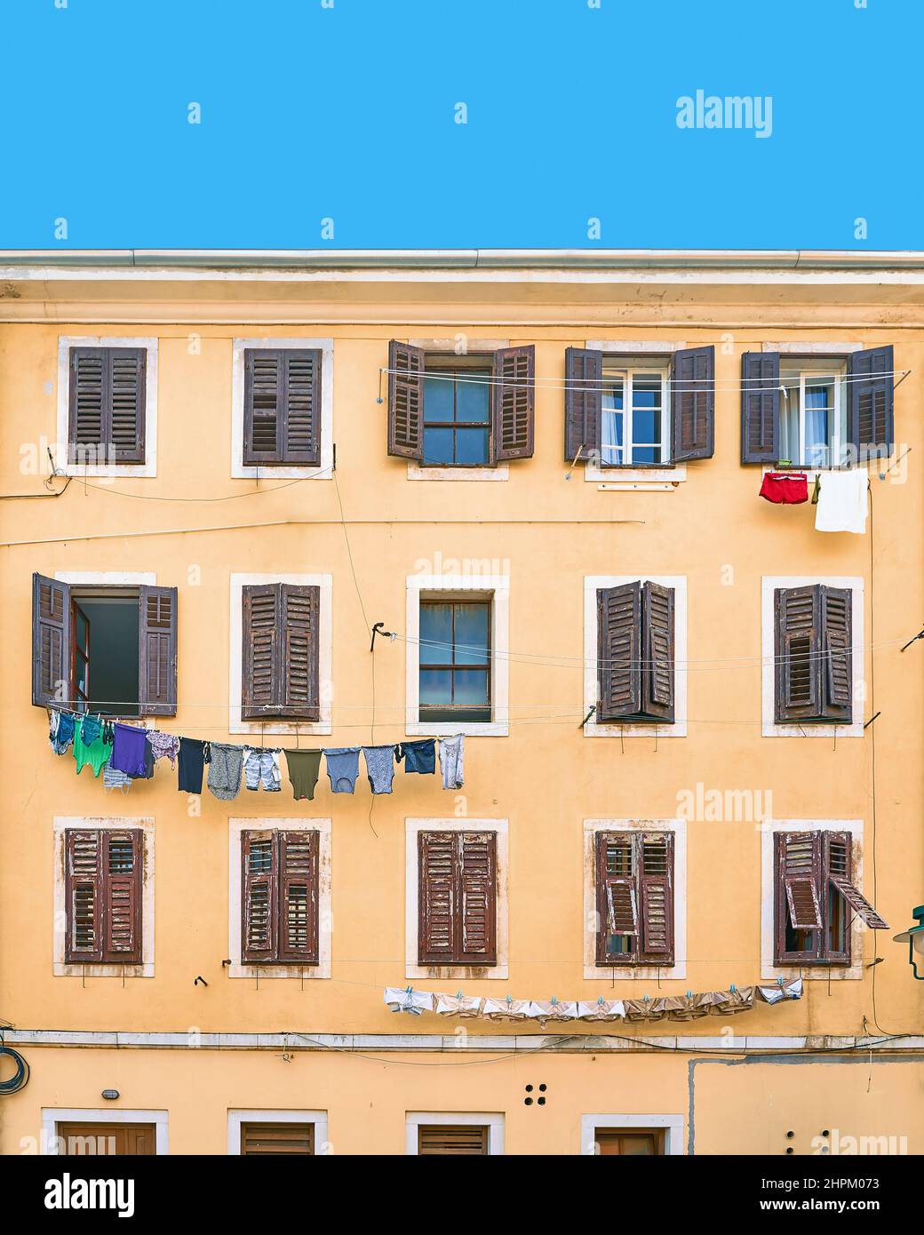Picturesque typical Italian slum residential house under a blue summer ...