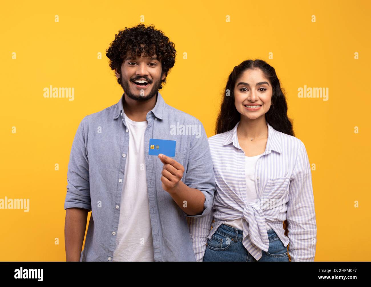 Easy contactless payments. Happy indian couple with credit card smiling ...