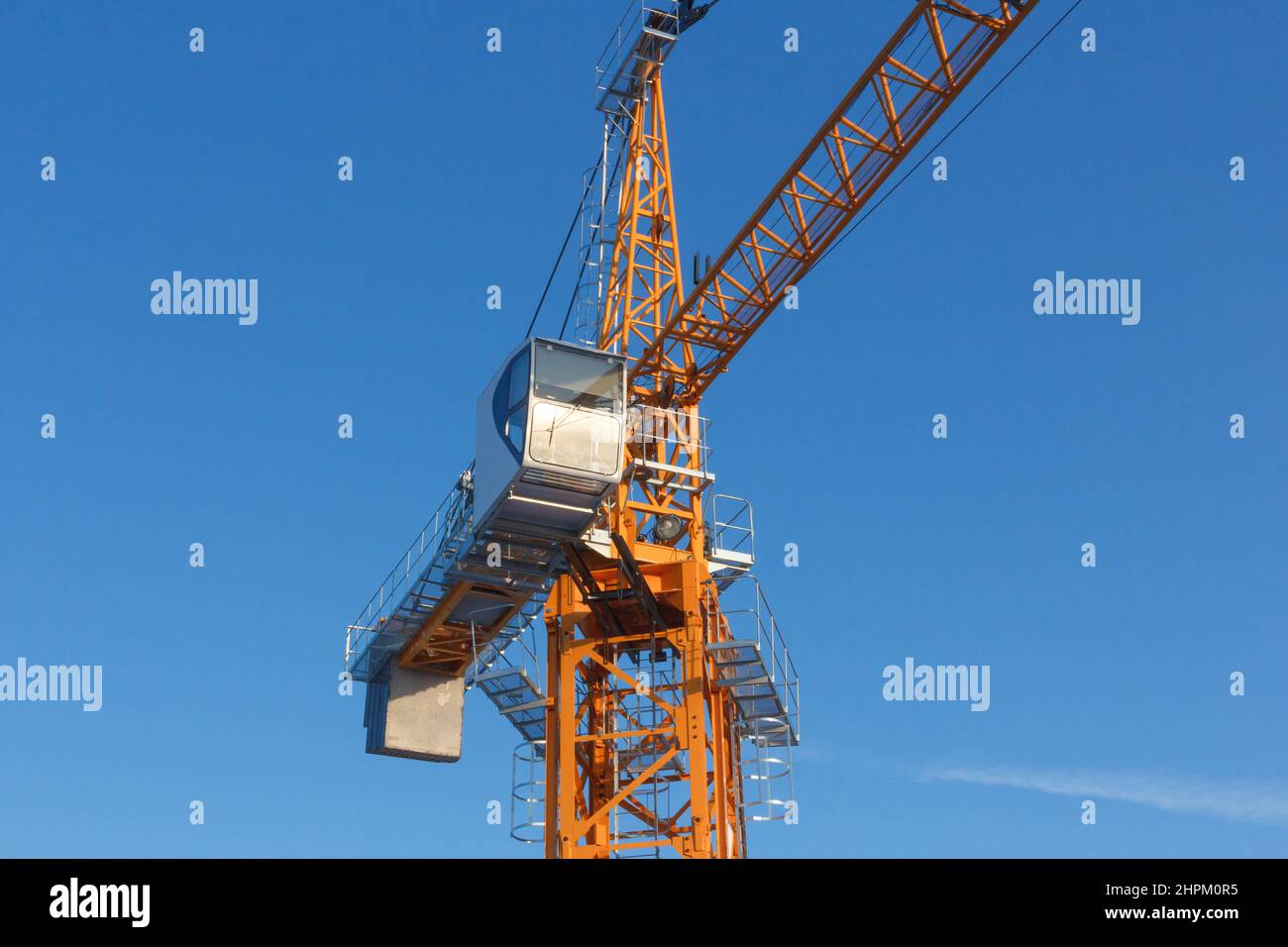 Tower crane against the blue sky. Tower crane operator's cabin. Crane ...