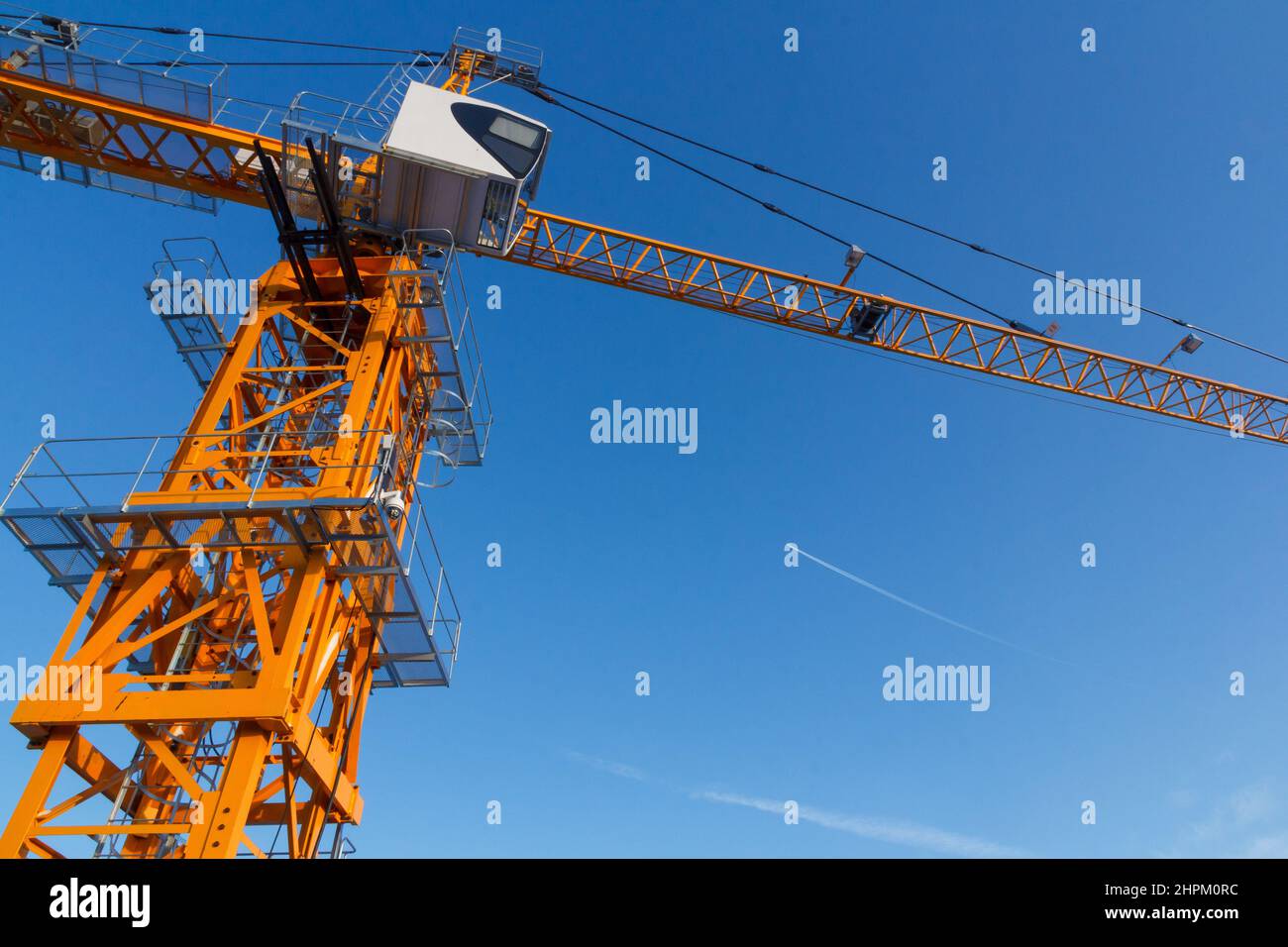 Tower crane against the blue sky. Tower crane operator's cabin. Crane ...