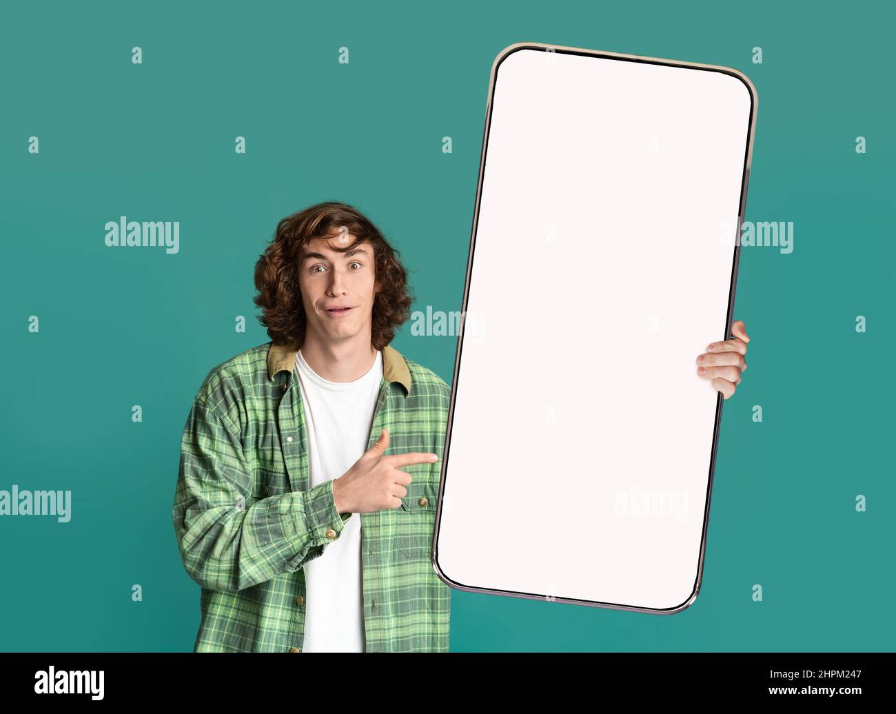 Shocked guy pointing at white empty smartphone screen Stock Photo - Alamy