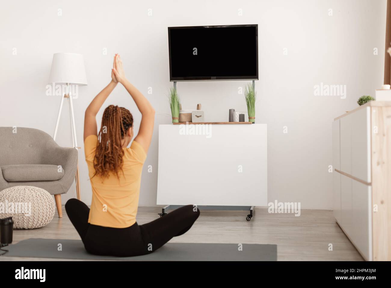 Woman watching video doing yoga hi-res stock photography and images - Alamy