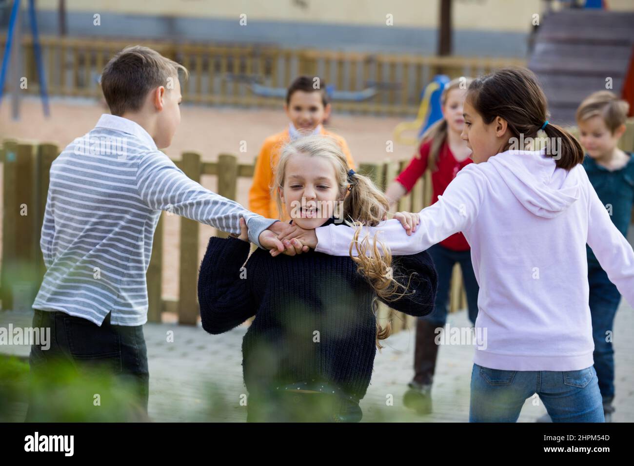 Positive kids playing forcing the city gates Stock Photo - Alamy