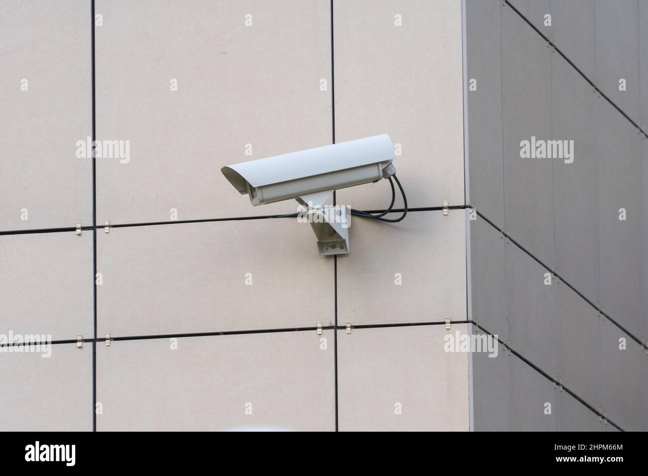 security camera on building wall Stock Photo - Alamy
