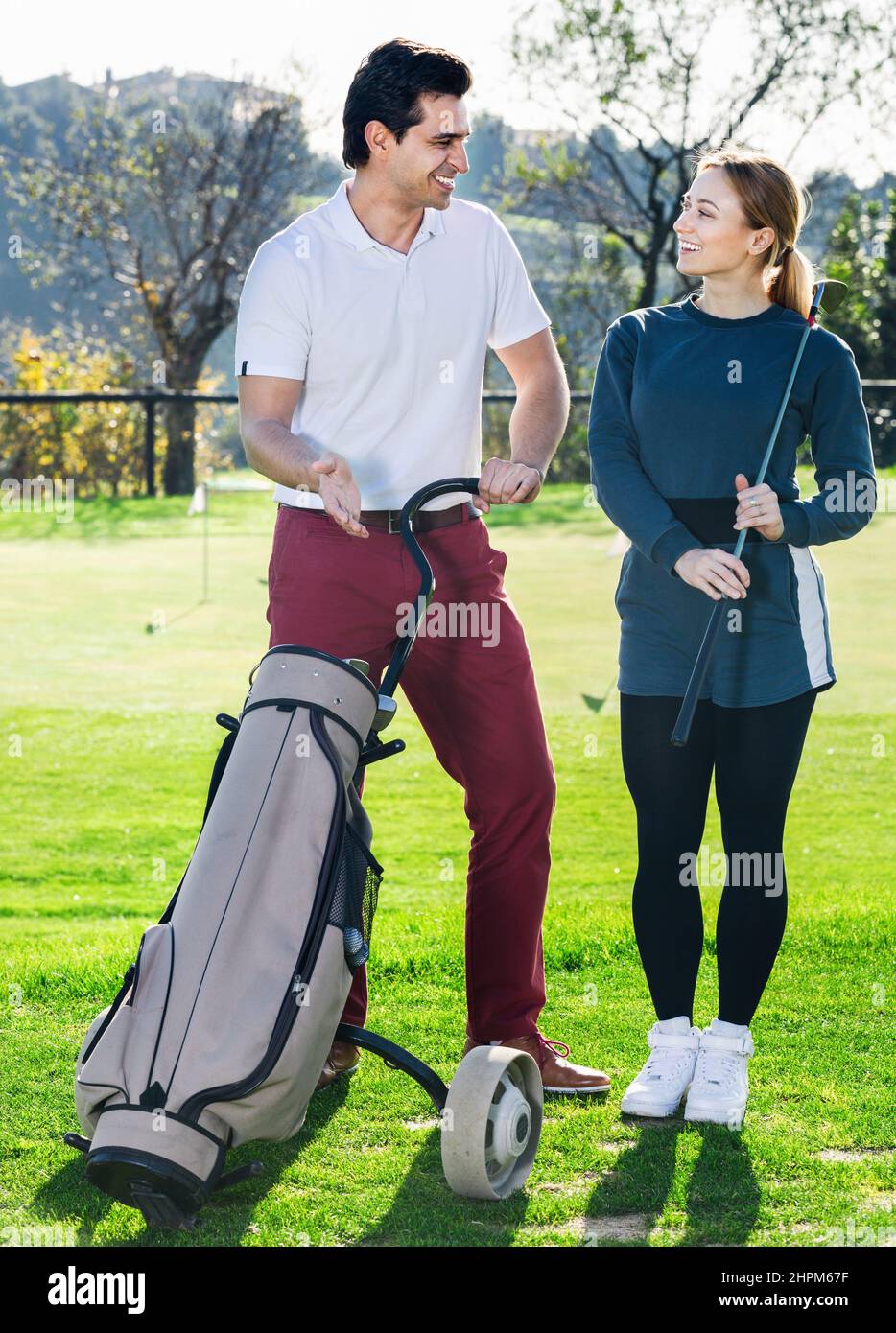 Man and woman golf partners ready to enjoy game Stock Photo - Alamy