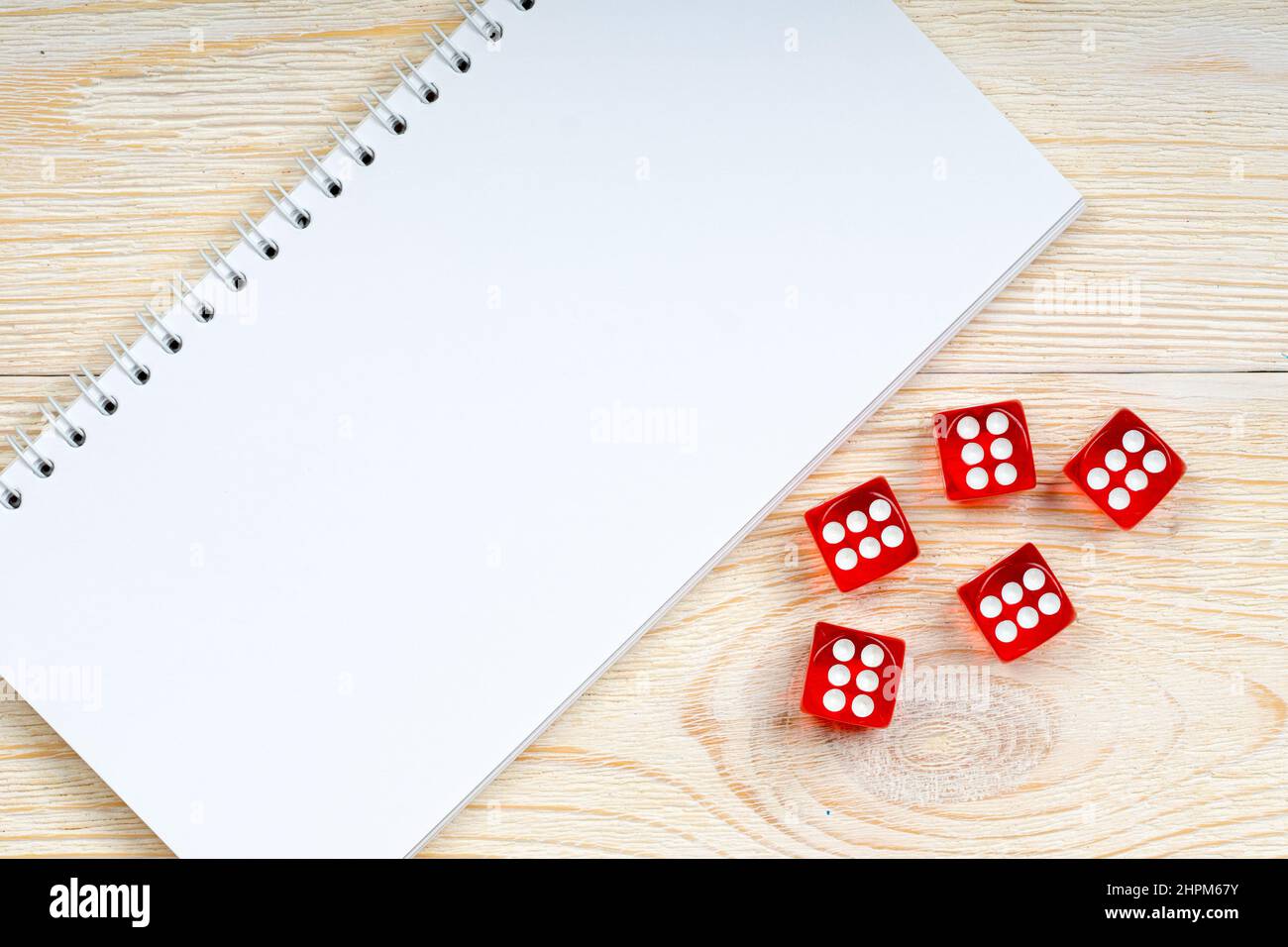 blank notepad with red dices with six over rustic wooden table Stock ...