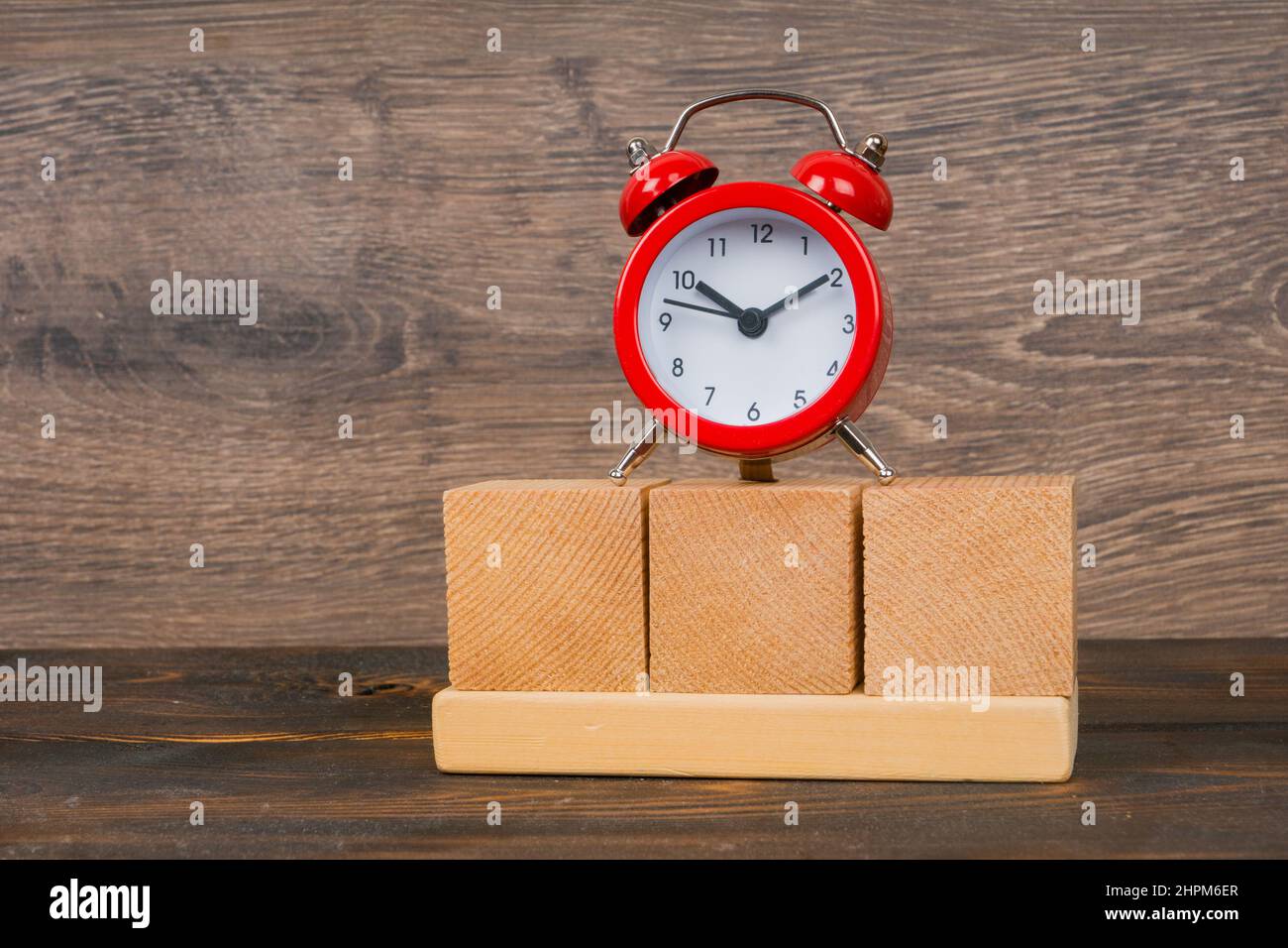 red alarm clock with 3 wooden toy blocks, template for countdown or ...