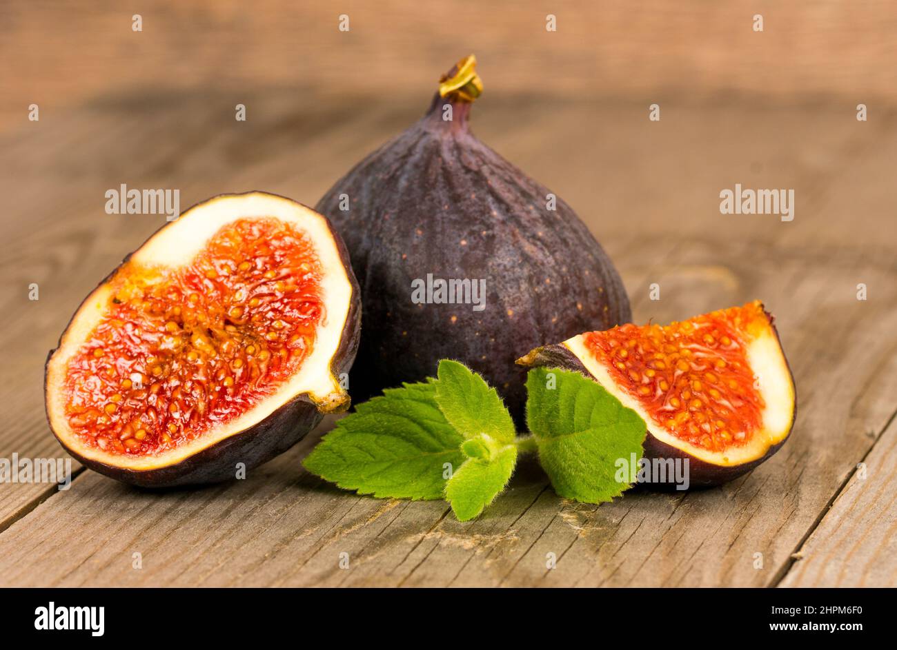 quarter half and whole ripe fig fruits on rustic wooden table Stock ...