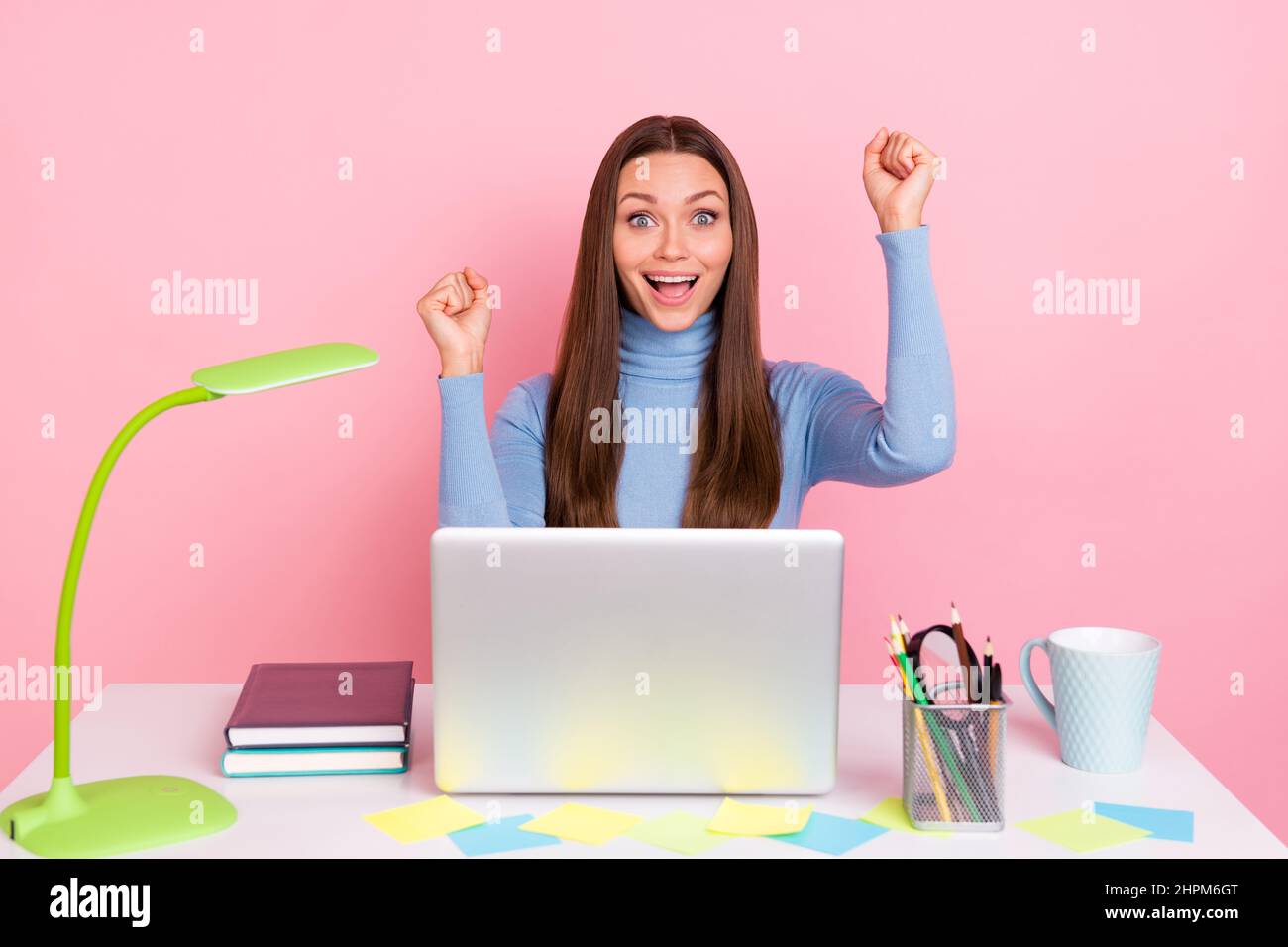 Photo of delighted lady manager sit desk use netbook fists-up celebrate ...