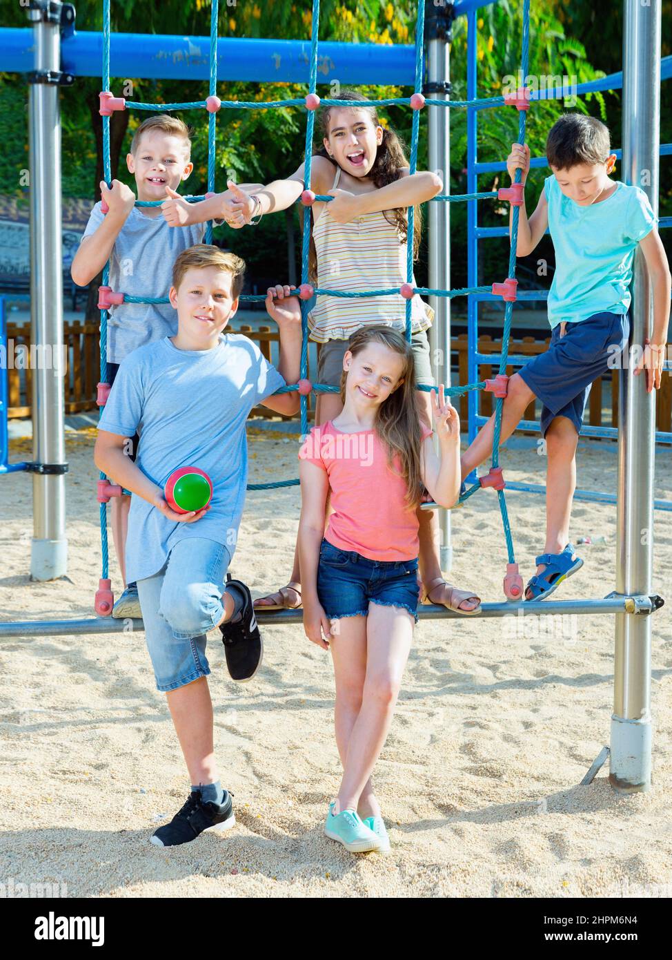 Five kids posing at the playground together Stock Photo - Alamy