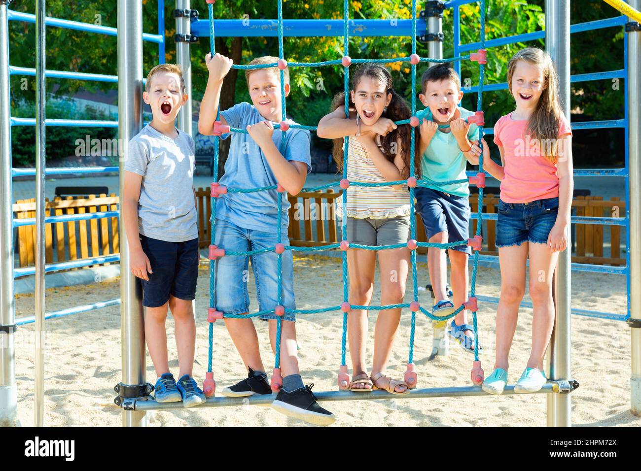 Five kids posing at the playground together Stock Photo - Alamy