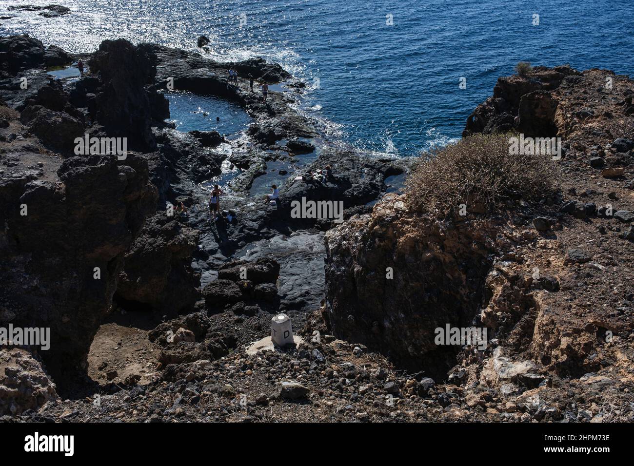 Rockpool on the coast with swimmers near to Los Abrigos, Tenerife ...