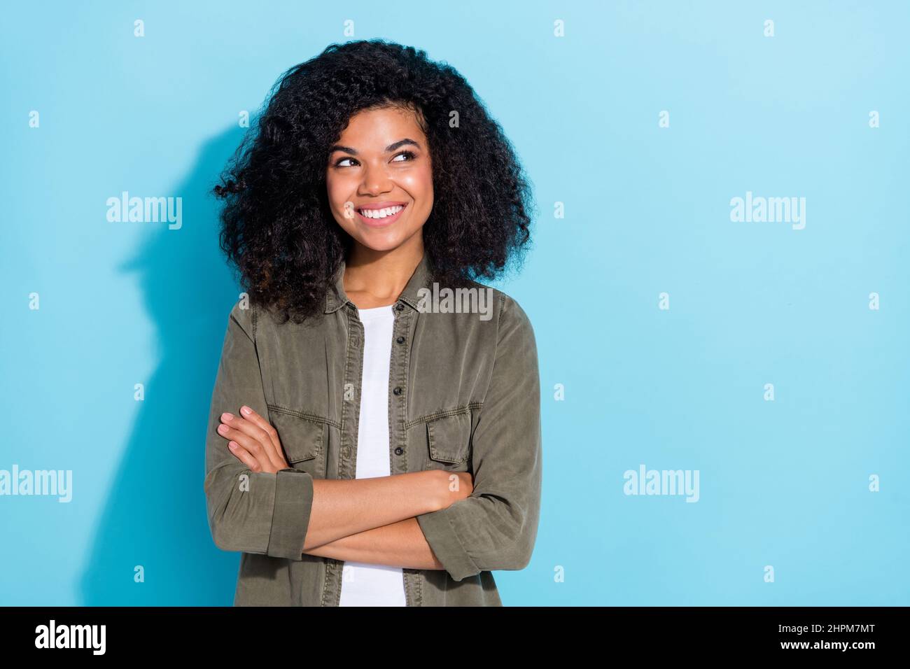 Photo of youth pretty african lady wonder look empty space folded hands ...