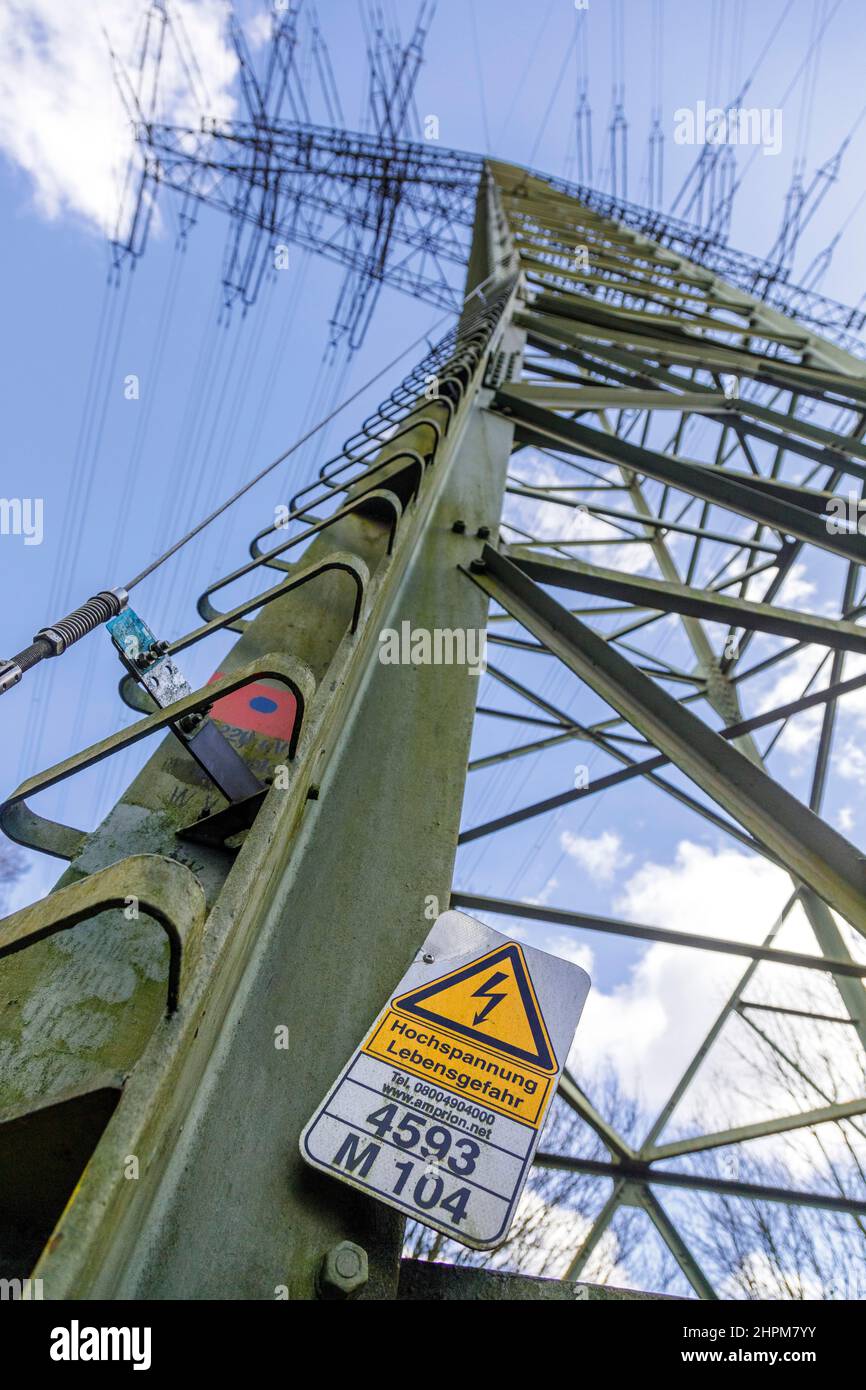 High voltage danger to life, warning sign on an overhead power line ...