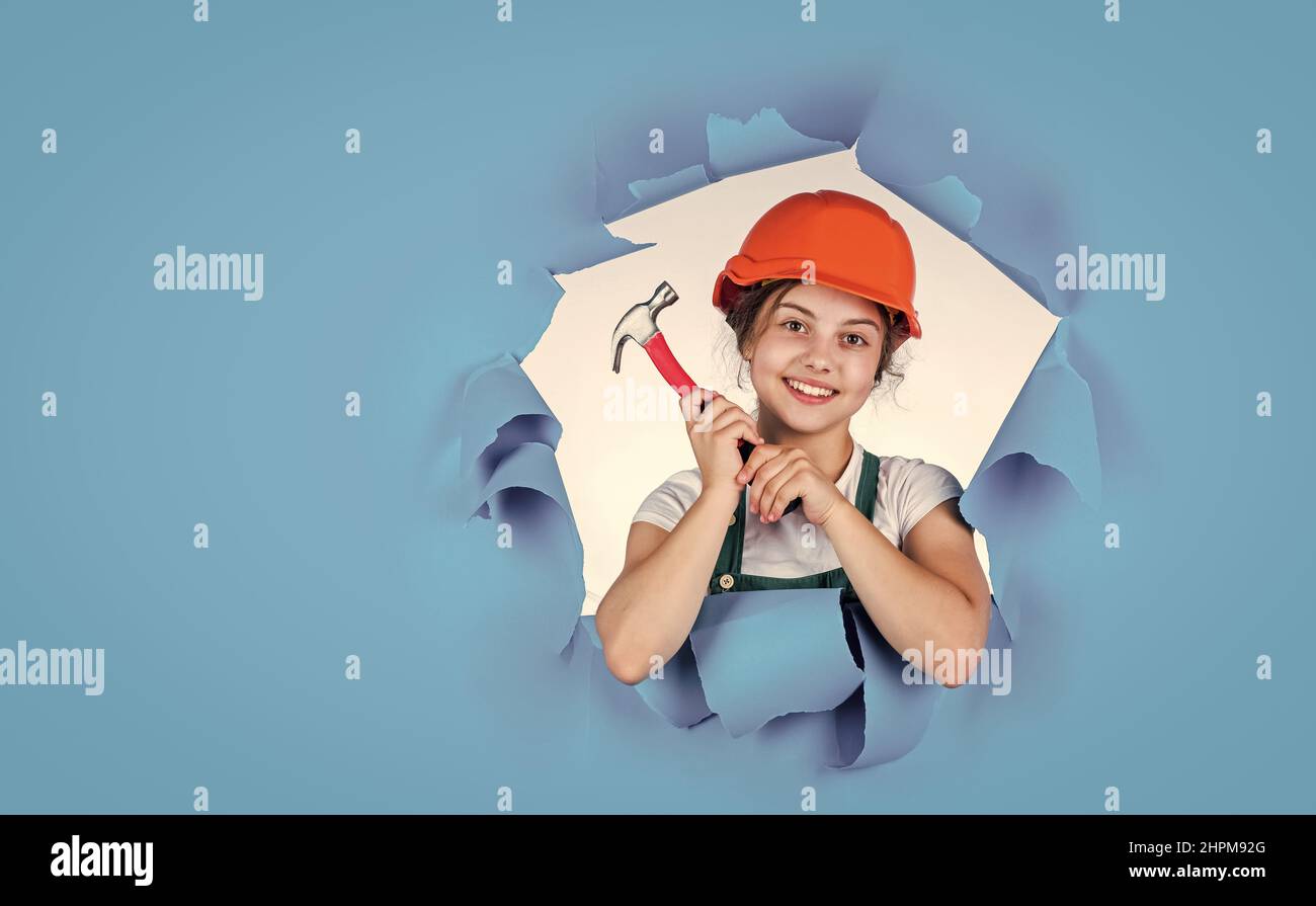 cheerful child laborer using building uniform and hammer, copy space ...