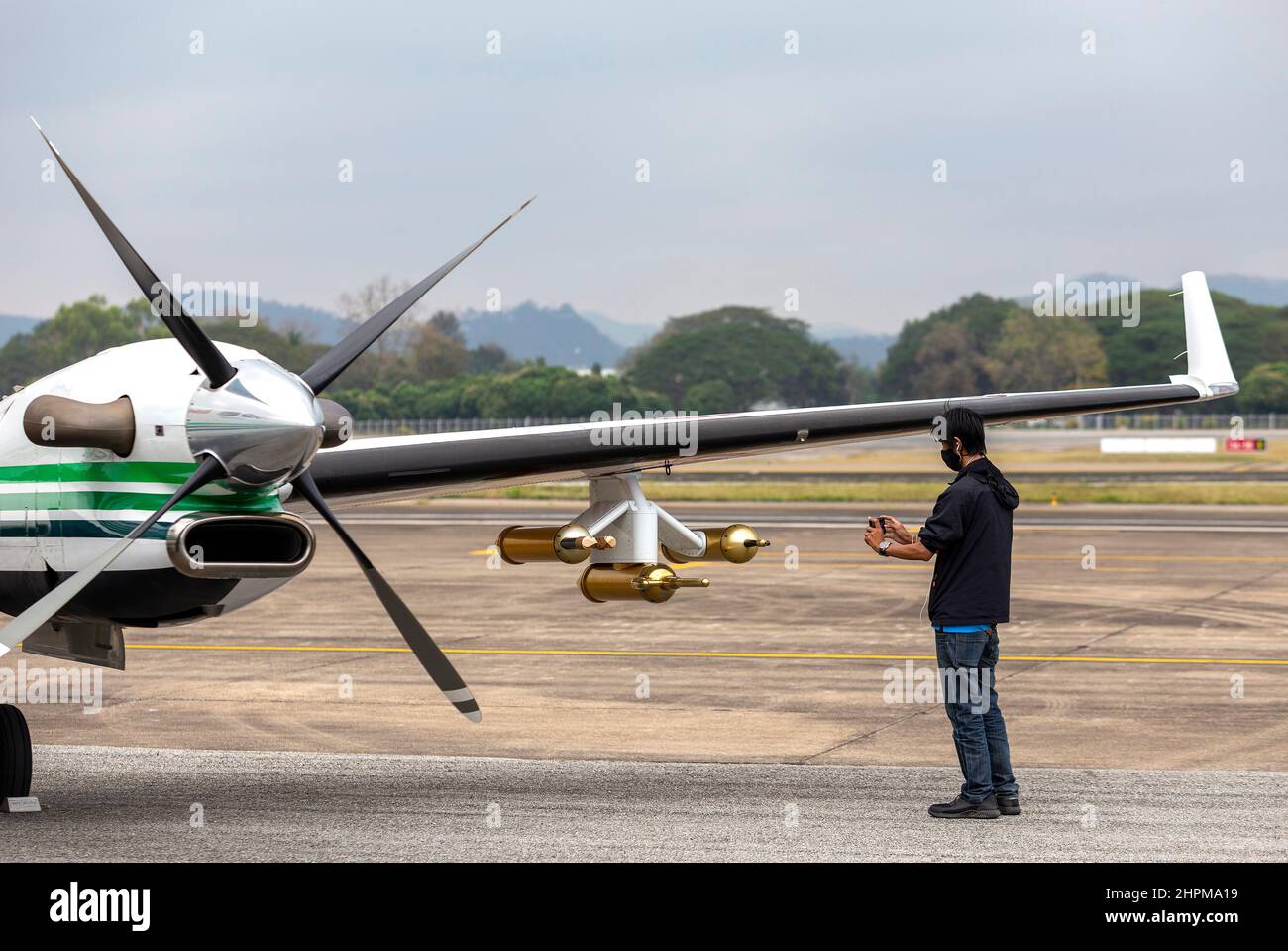 A man takes photos of an aircraft Super King Air 350 from Department of ...