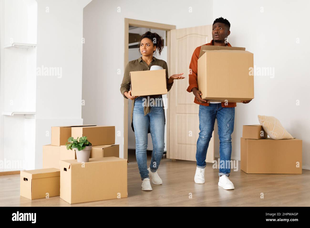 Discontented African American Couple Carrying Moving Boxes Indoor Stock ...