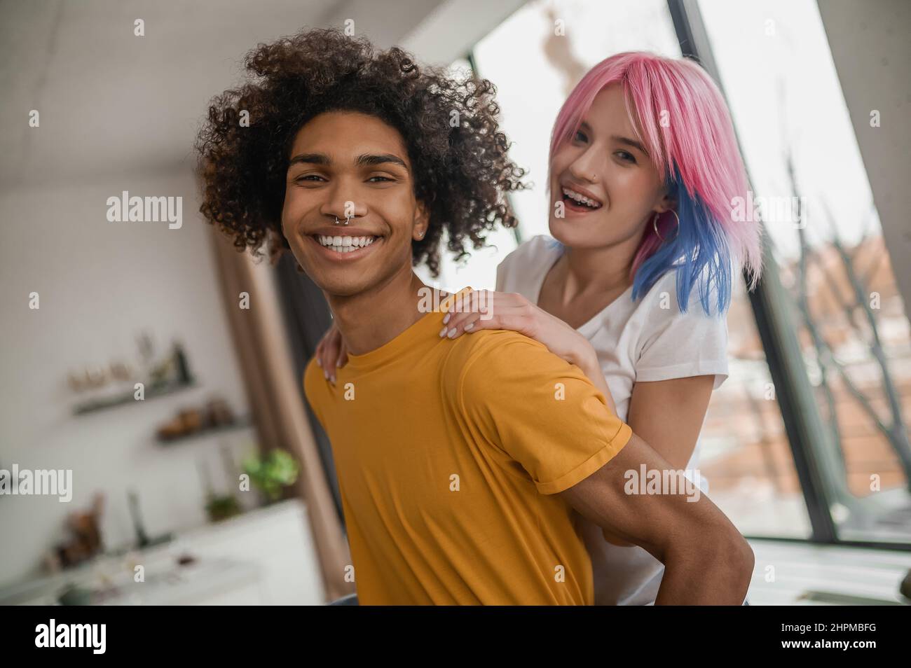 Young people having fun together at home and looking happy Stock Photo ...