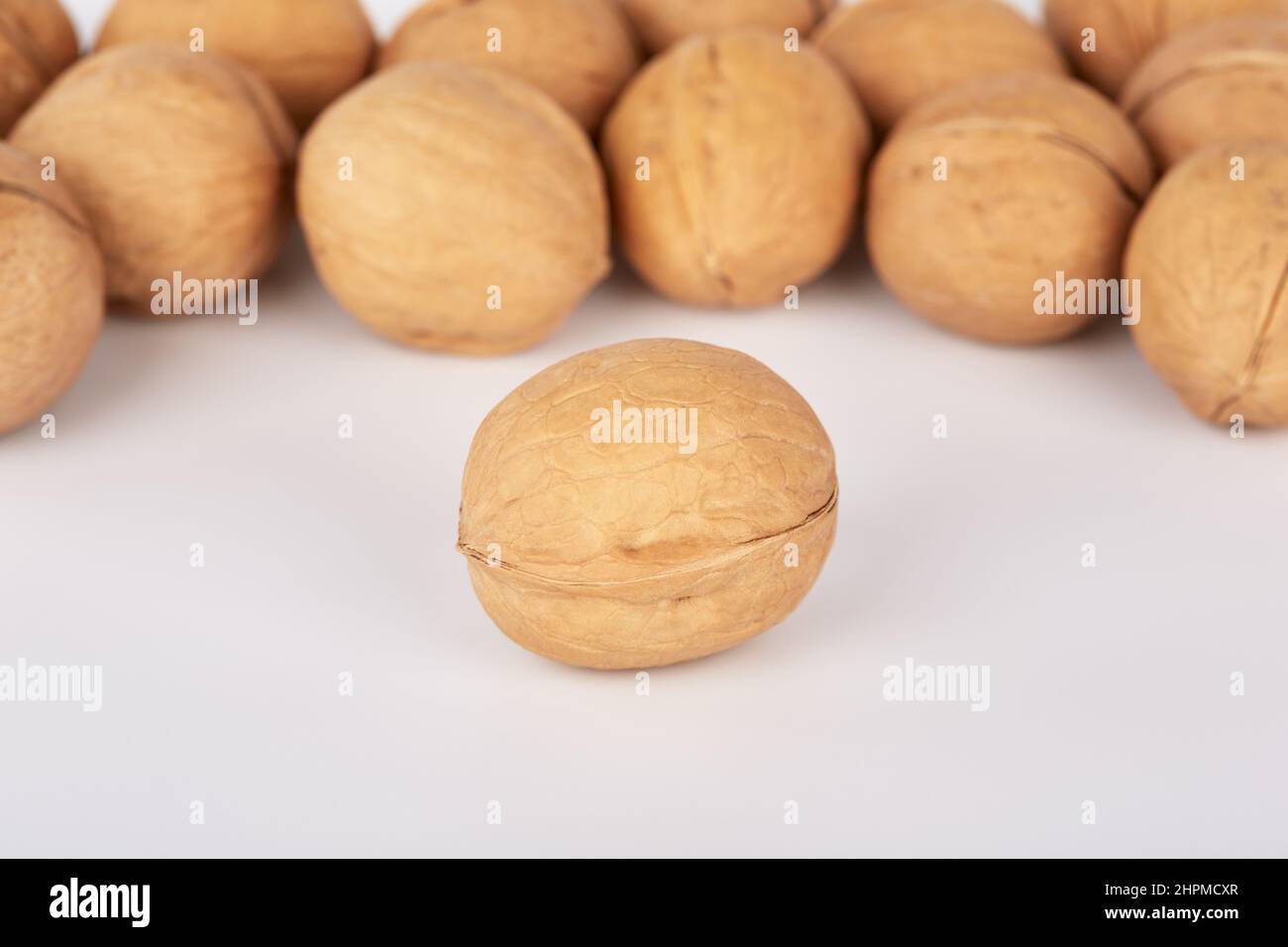 Many walnuts on a white background one nut lies separately Stock Photo ...
