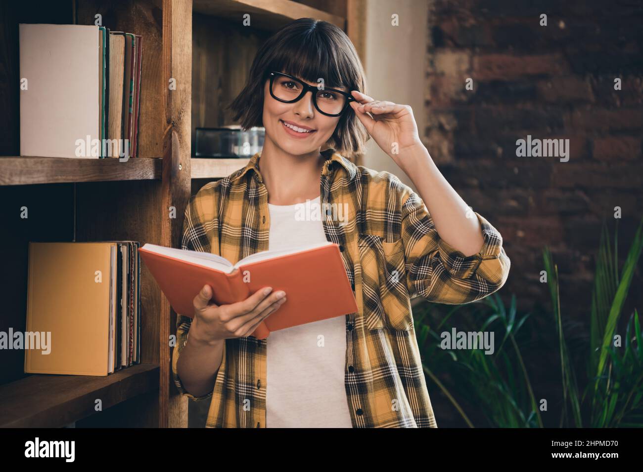 Portrait of beautiful charming lovely intelligent girl reading book ...