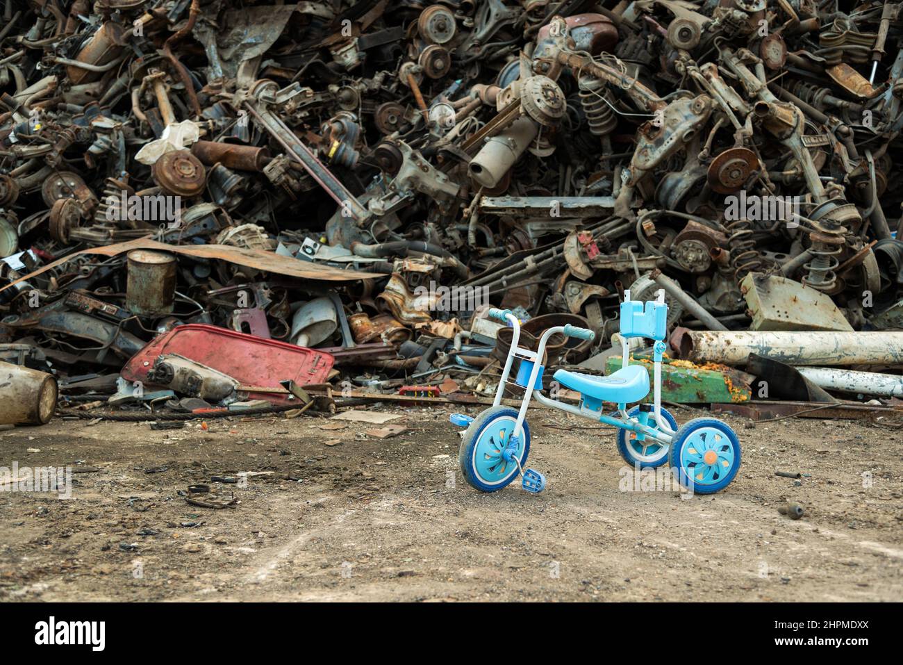 Large tracked excavator working a steel pile at a metal recycle yard ...